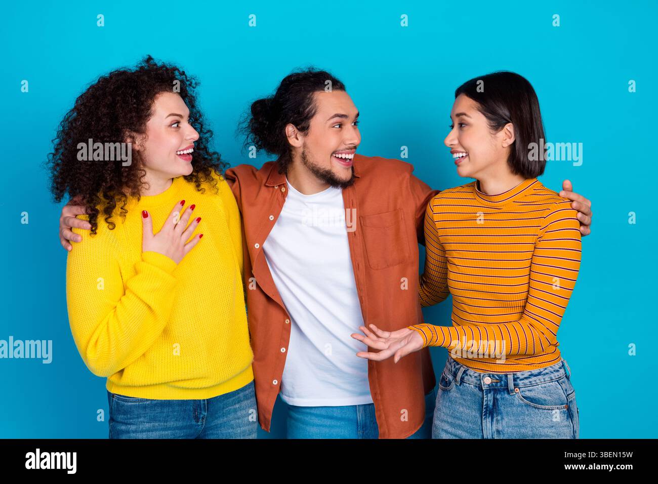 Group of cheerful young friends bonding in casual outfits against a ...