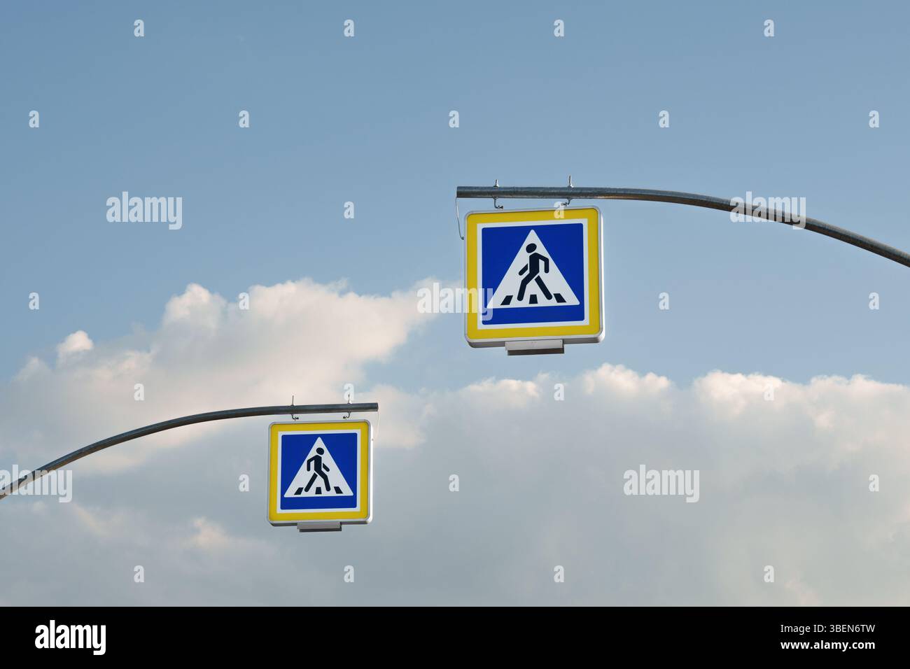 Two pedestrian crossing signs under blue sky close-up. Urban planning ...