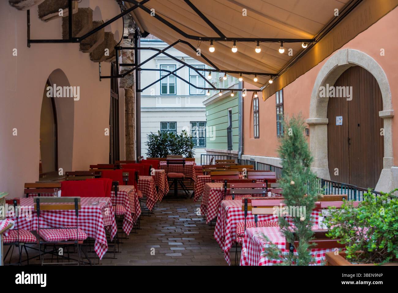 Cozy outdoor seating area of a traditional restaurant. With red and ...