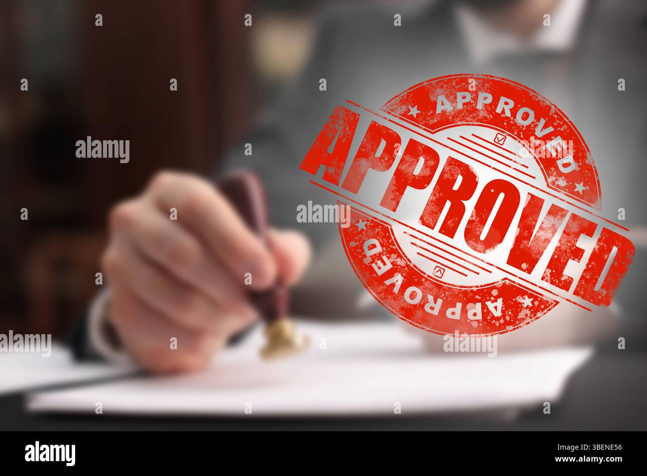 Man stamping document at table and red stamp Approved Stock Photo - Alamy