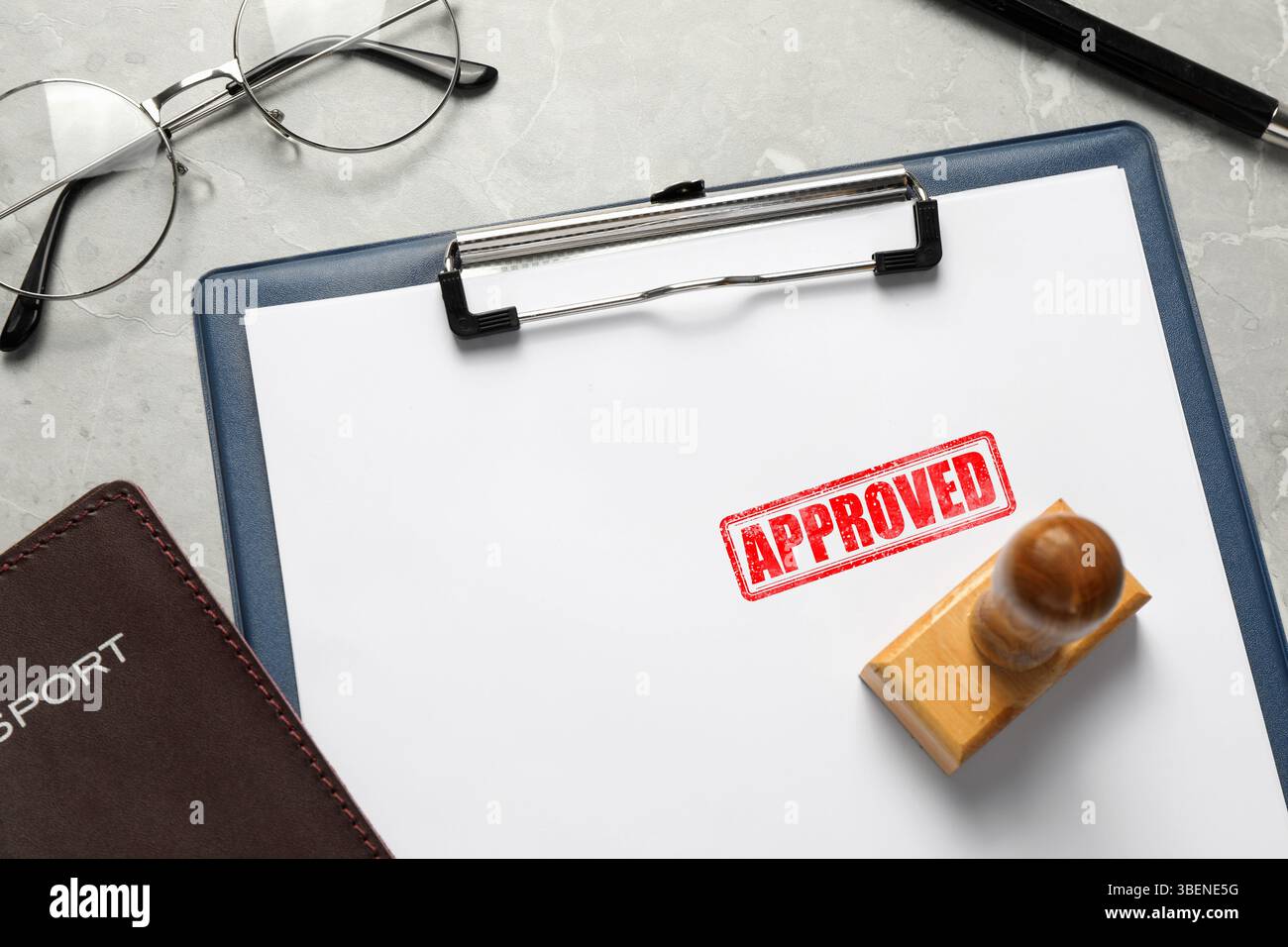 Sheet of paper with red stamp Approved, passport and wooden stamp on ...