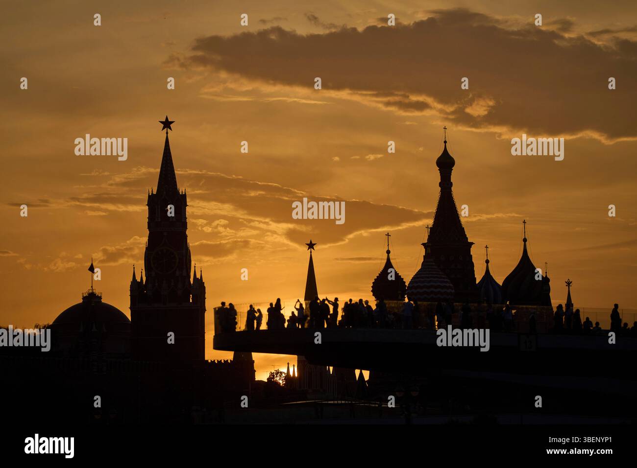 People watch and photograph sunset behind the Kremlin standing on the ...