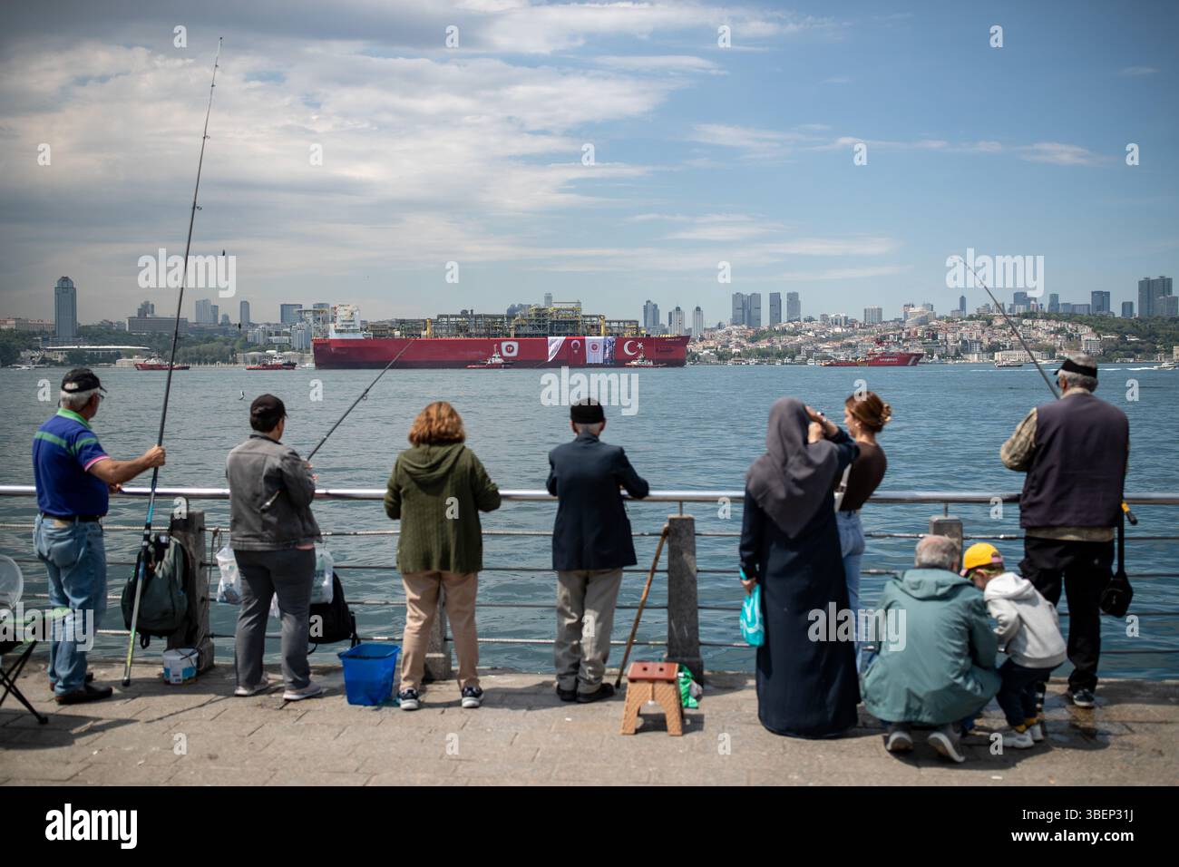 Istanbul, Turkey. 29th May, 2025. People are watching the ship passing ...
