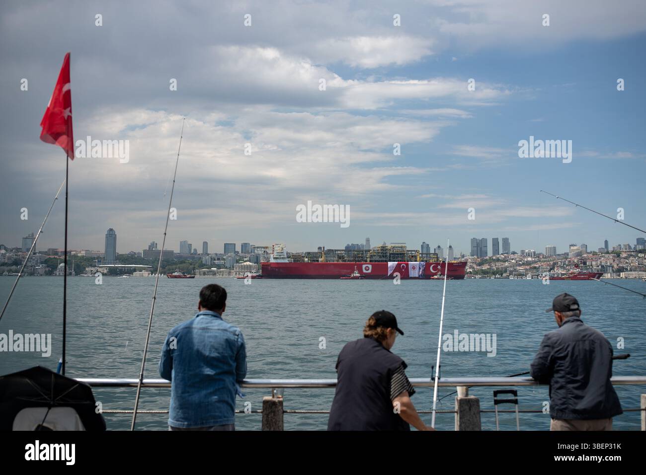People are watching the ship passing through the Bosphorus on the ...