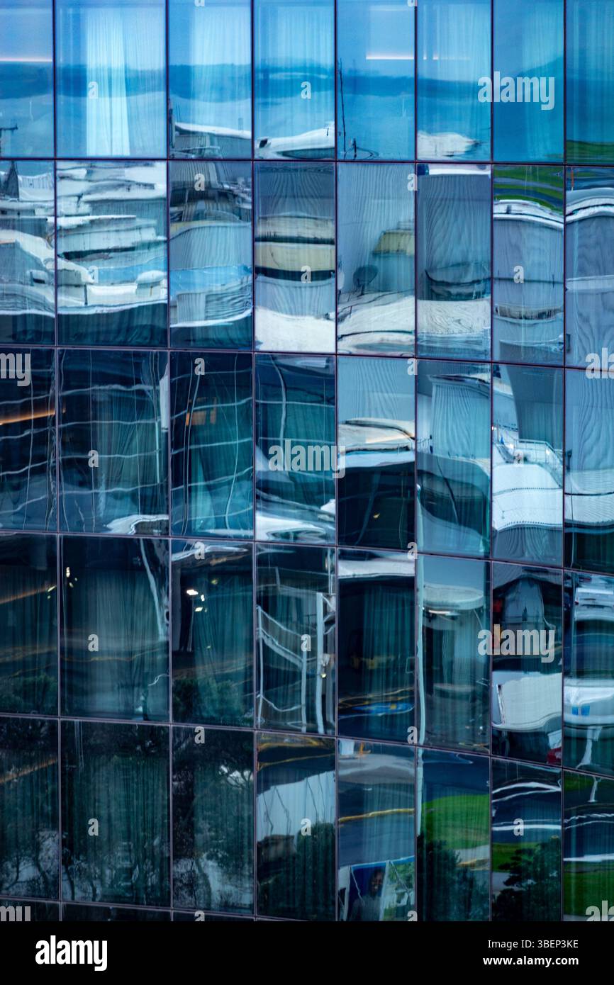 Windows reflections in grid pattern on side of commercial building ...