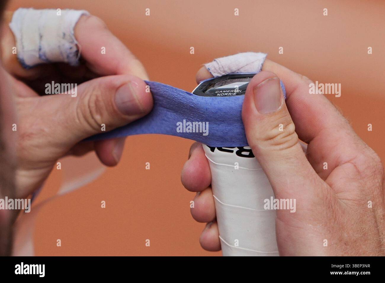 Britain's Cameron Norrie changes his racket's overgrip as he plays ...