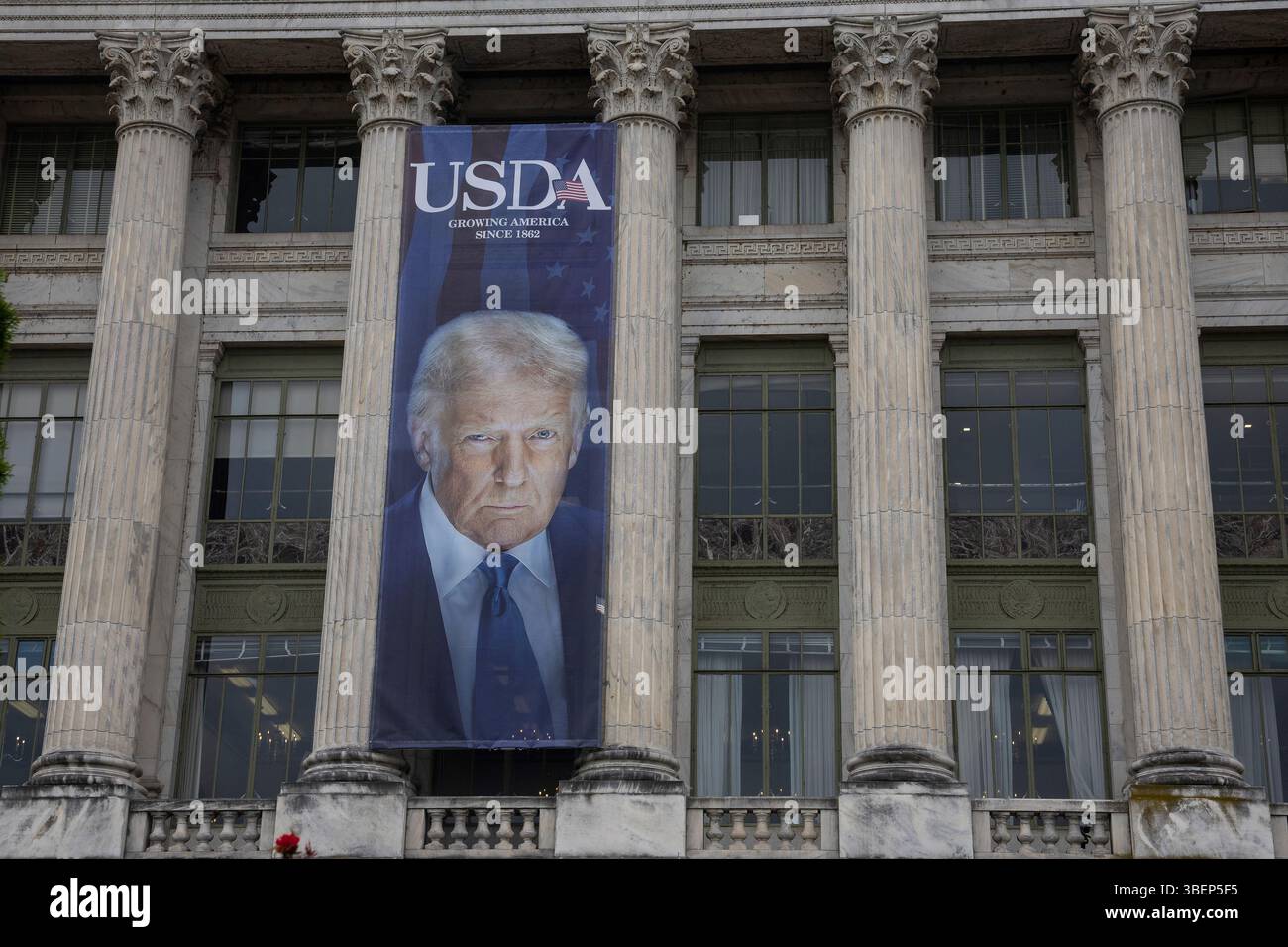 A banner with an image of President Donald Trump hangs outside ...