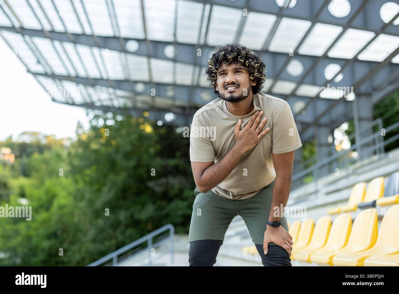 Hispanic man clutching chest pain hi-res stock photography and images ...