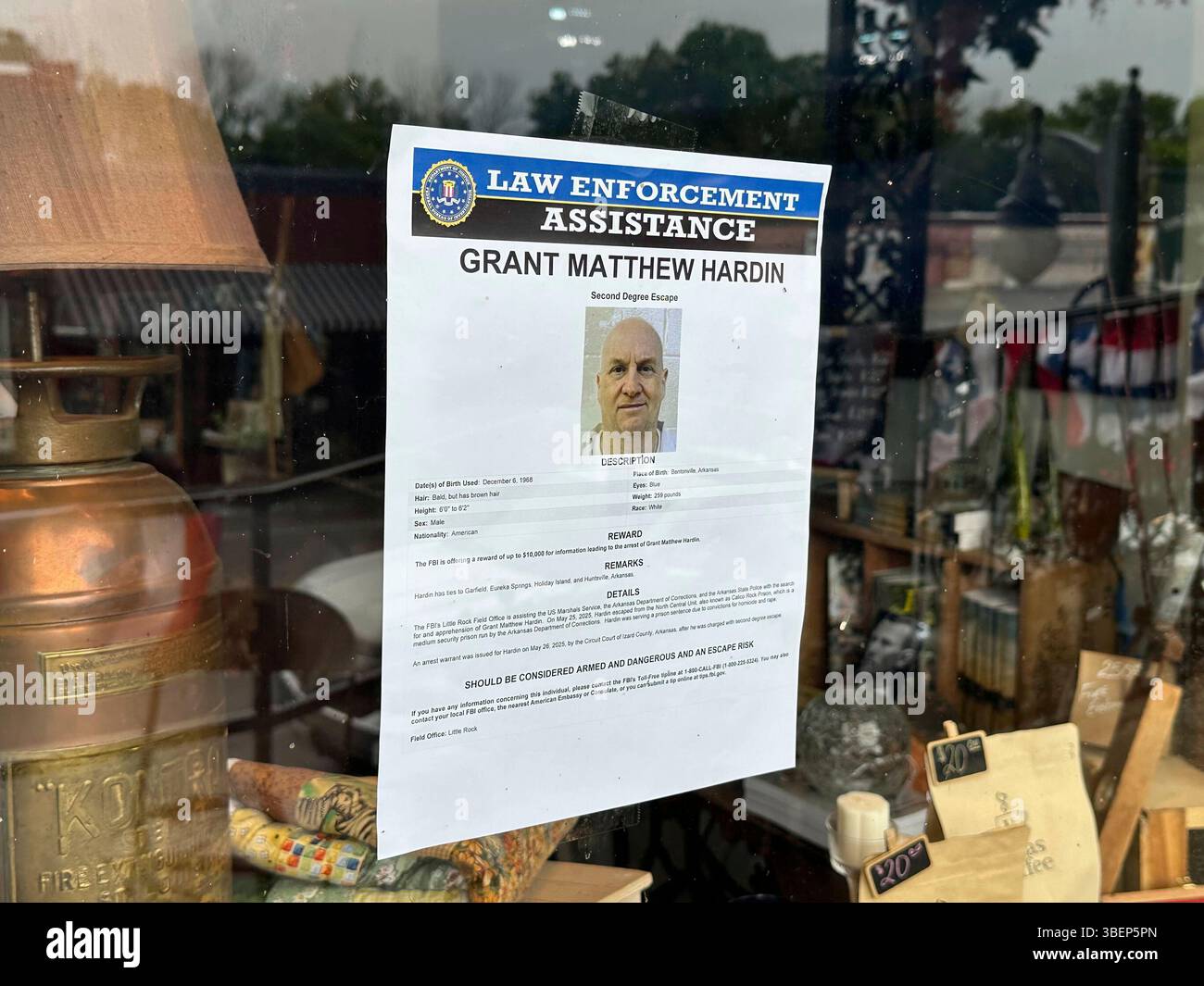 A flier looking for Grant Hardin hangs on the glass of a business ...