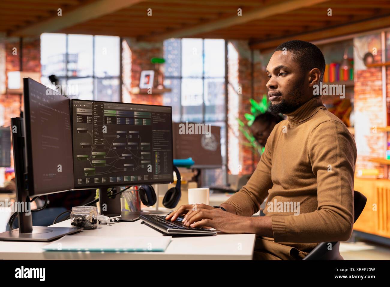 IT engineer using PC in innovative startup office and programming languages to build ...