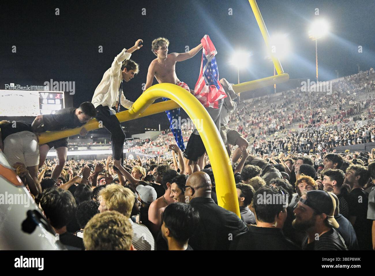 FILE - Vanderbilt fans climb a goalpost as they celebrate on the field ...