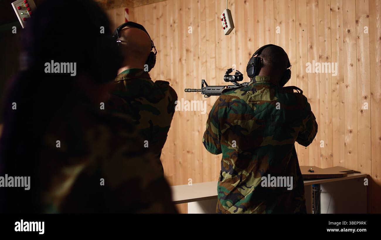 Team of army soldiers practicing with firearms in shooting range to ...