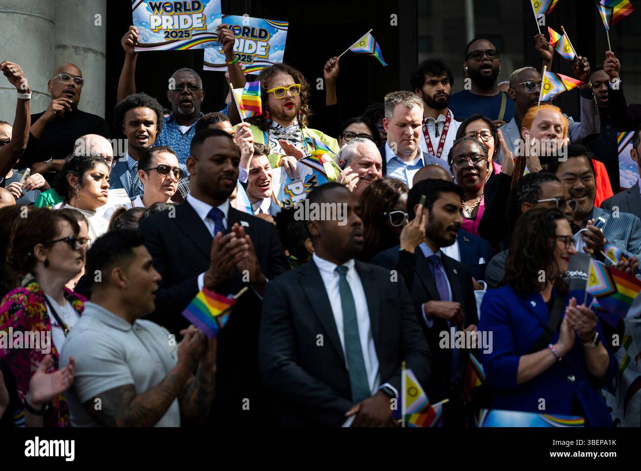 Attendees celebrate during a flag raising ceremony for World Pride ...