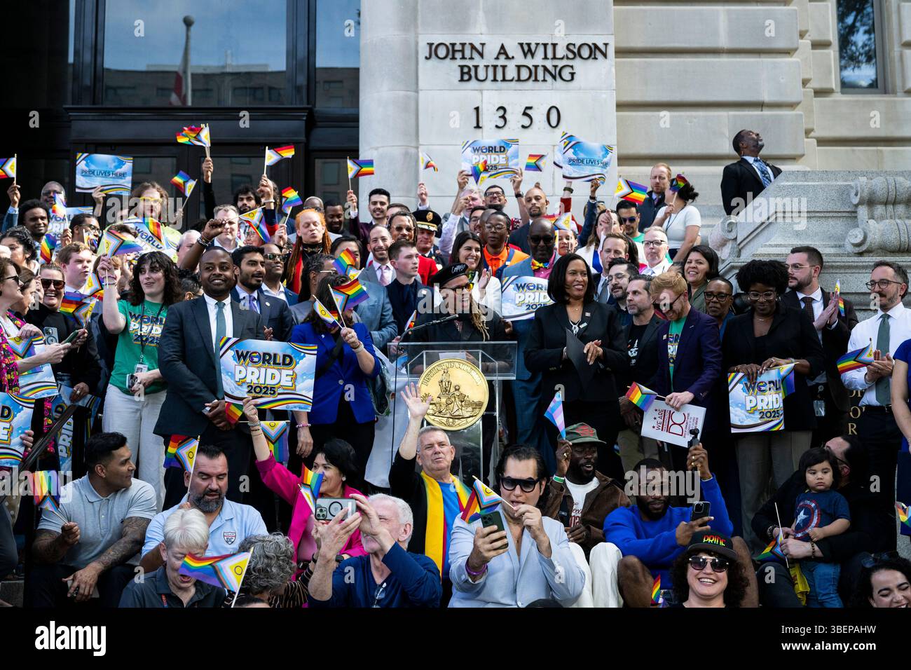 Attendees celebrate during a flag raising ceremony for World Pride ...