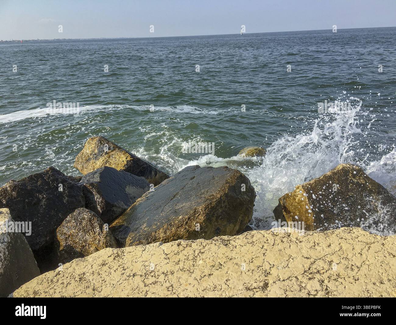 Water splash at a rock on the beach Stock Photo - Alamy