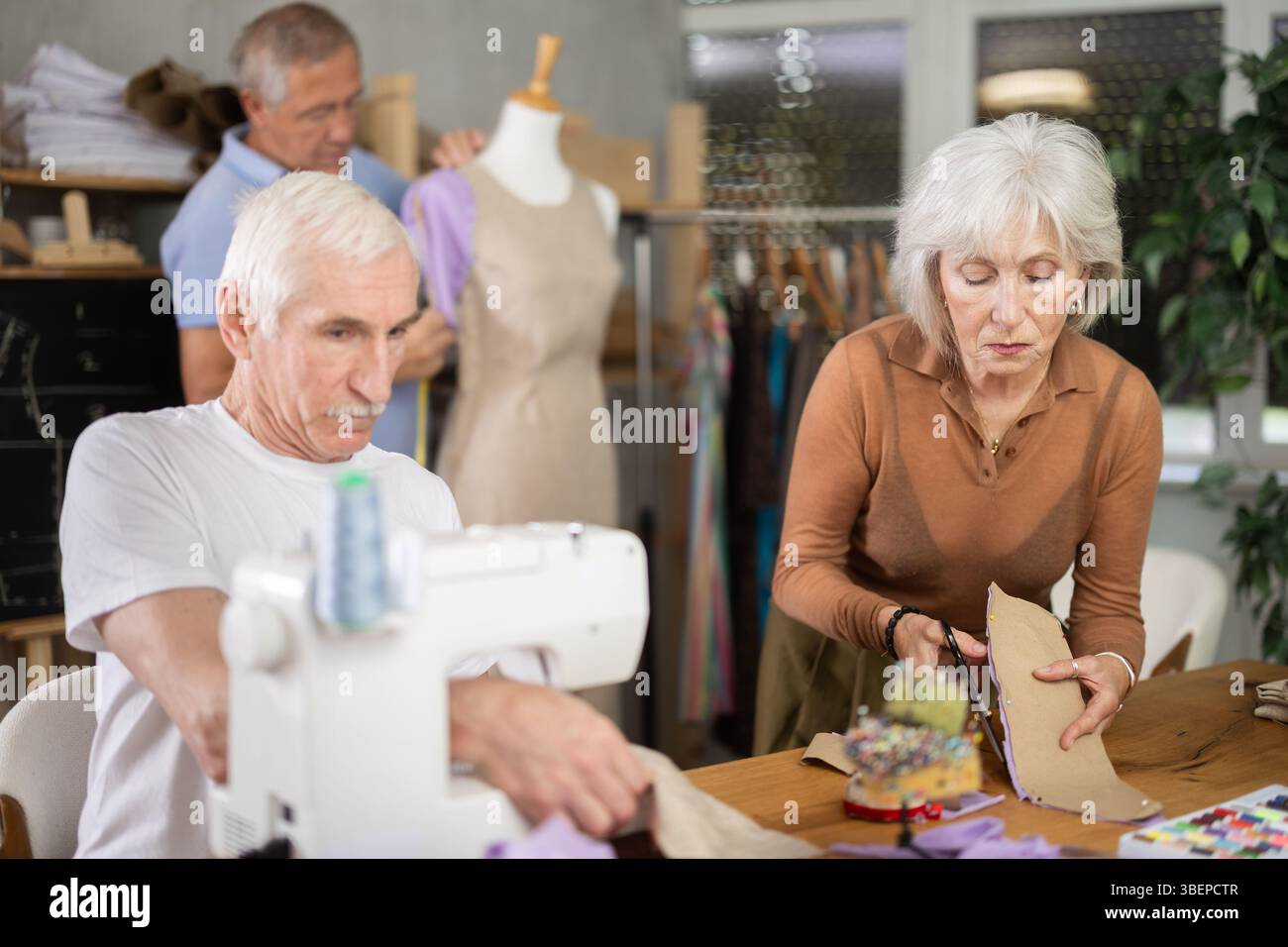 Group of elderly people at sewing master class Stock Photo - Alamy
