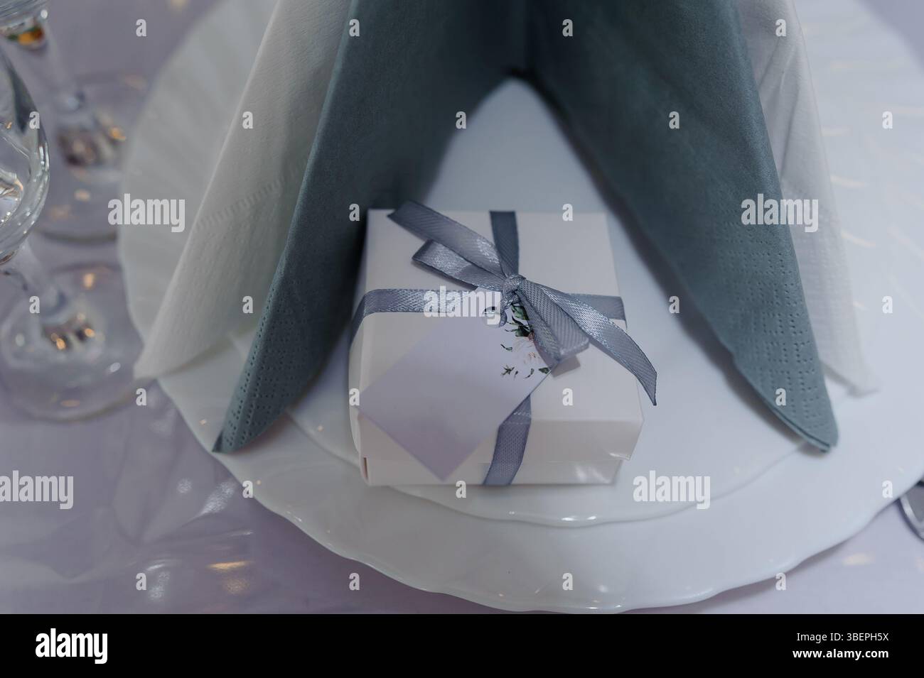 Elegant wedding favor presentation featuring a small white gift box ...