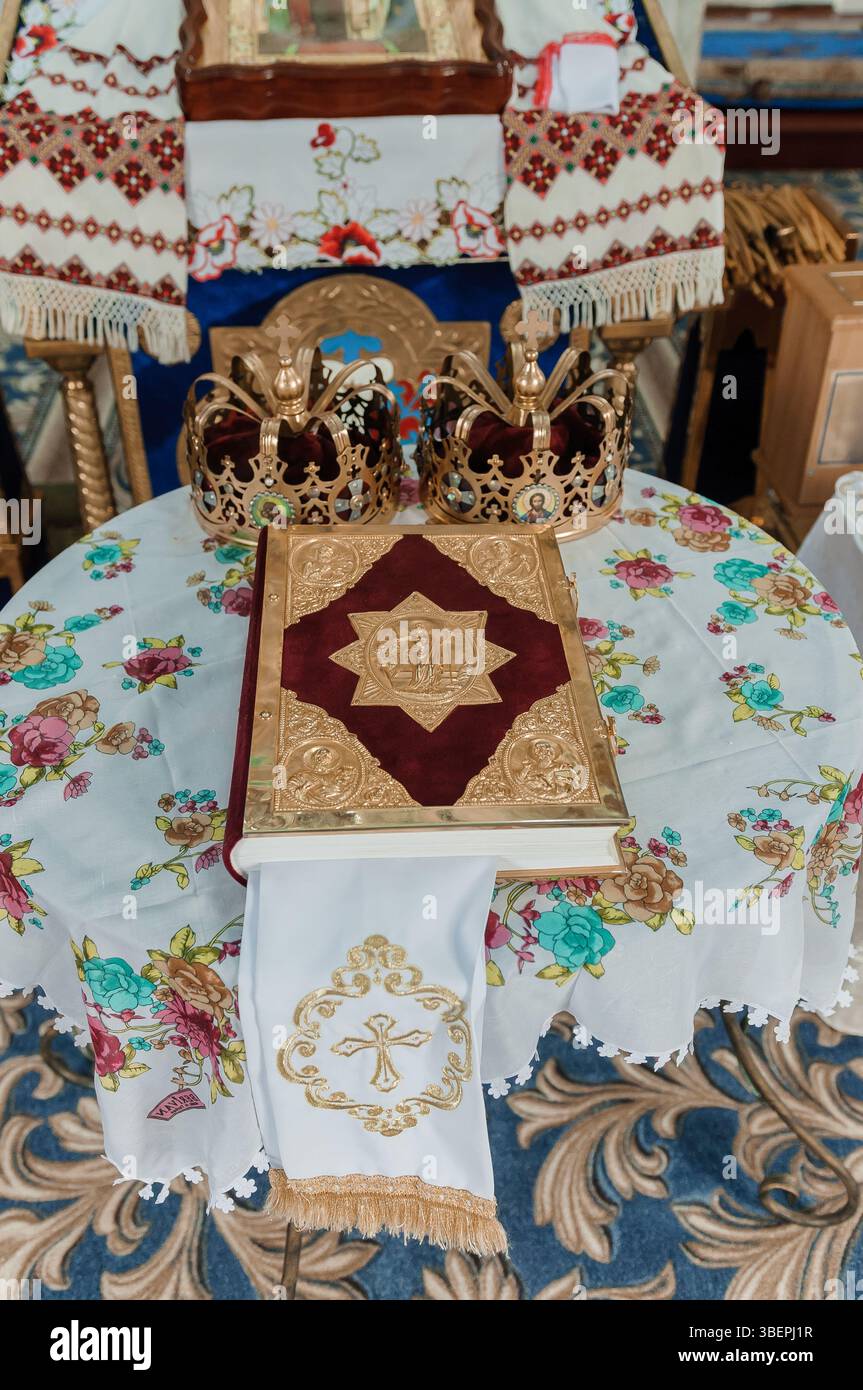 A richly decorated church altar setting with a golden crown, a dark-red ...