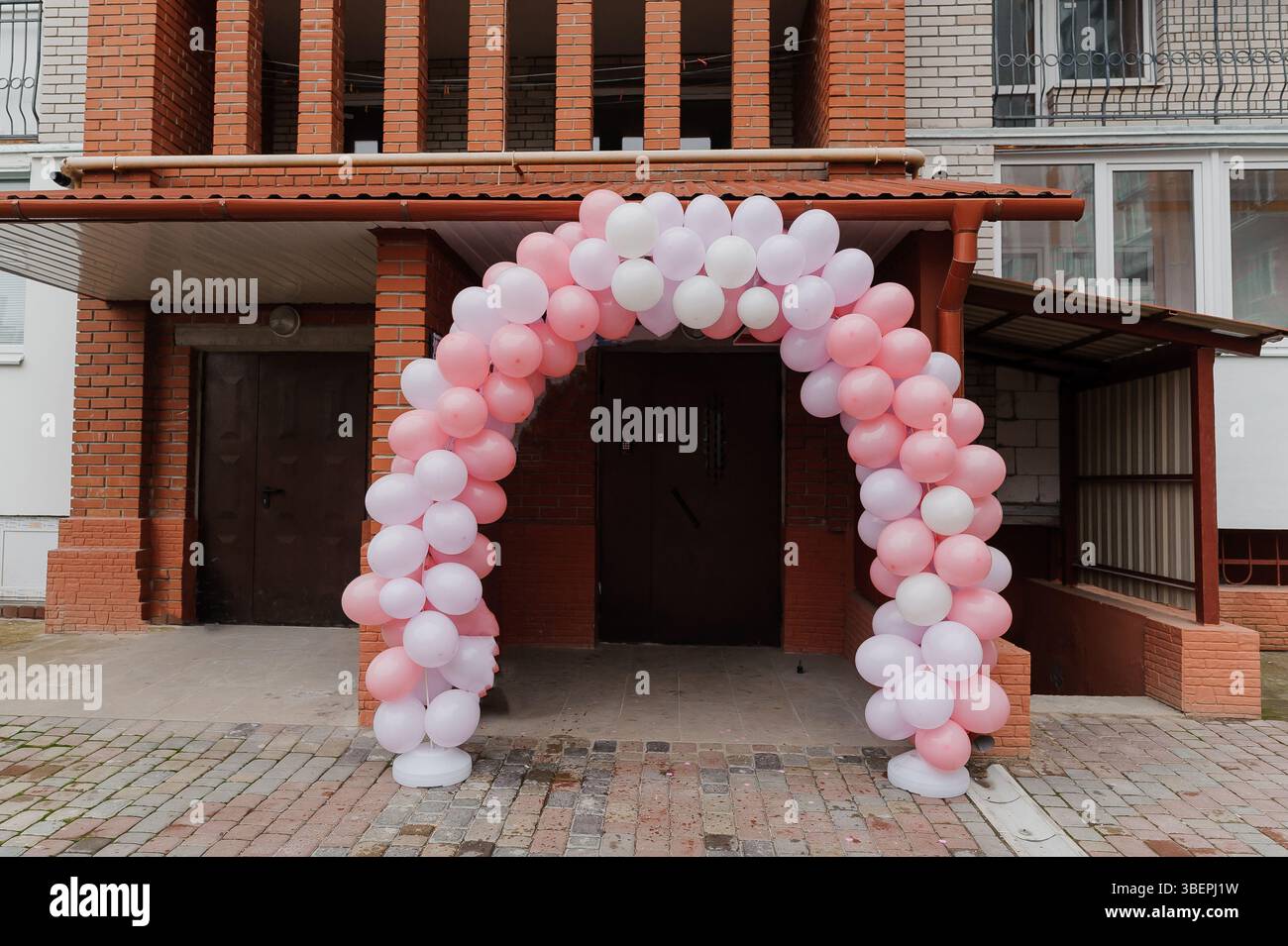 Pink and White Balloon Archway Decorating a Building Entrance for ...