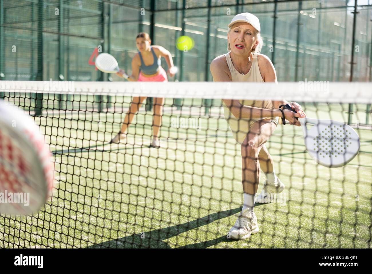 Old woman playing Padel Tennis in open-air tennis court Stock Photo - Alamy