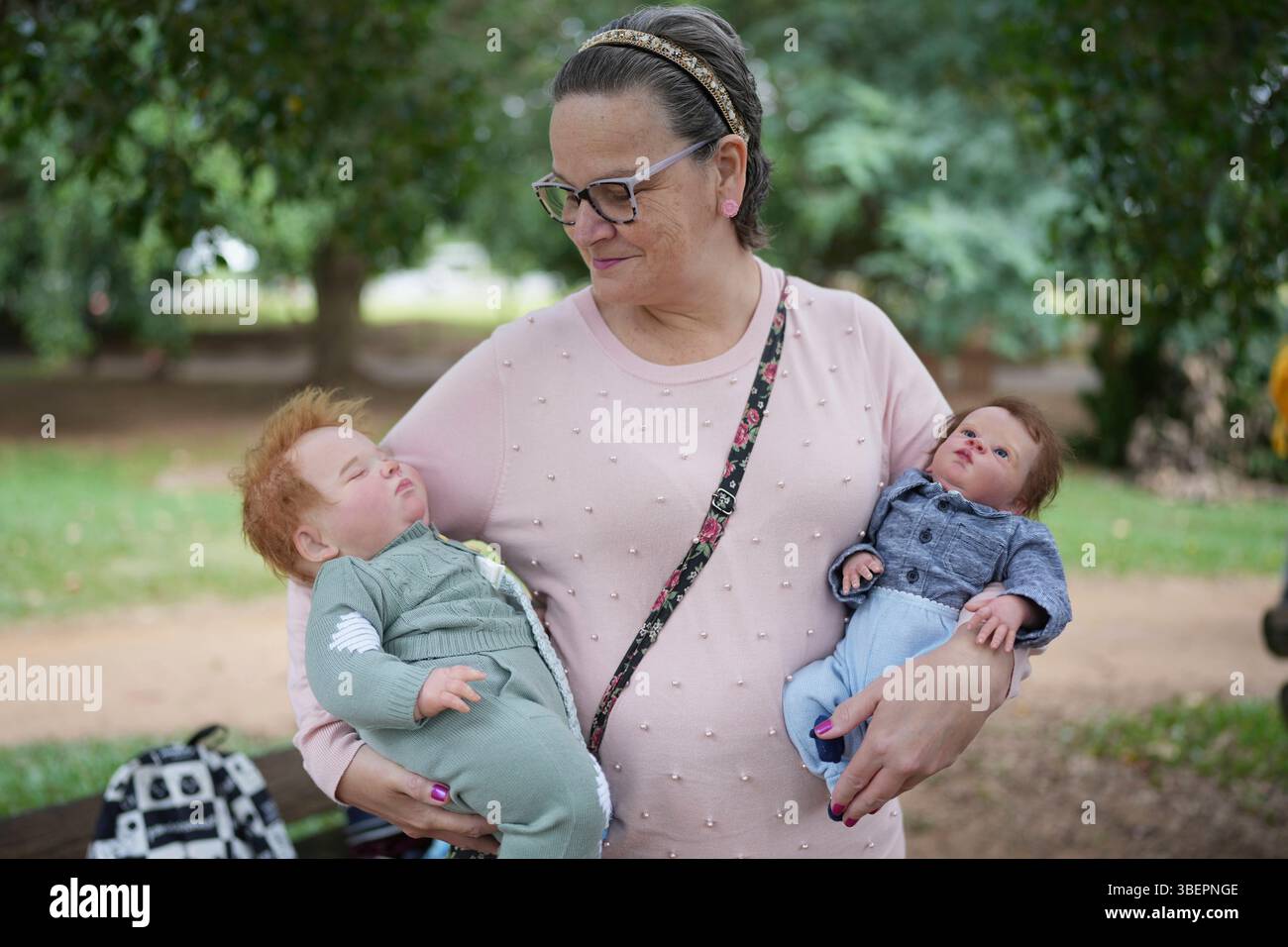 Ana Paula Vilela holds her dolls during a group gathering to bond and ...
