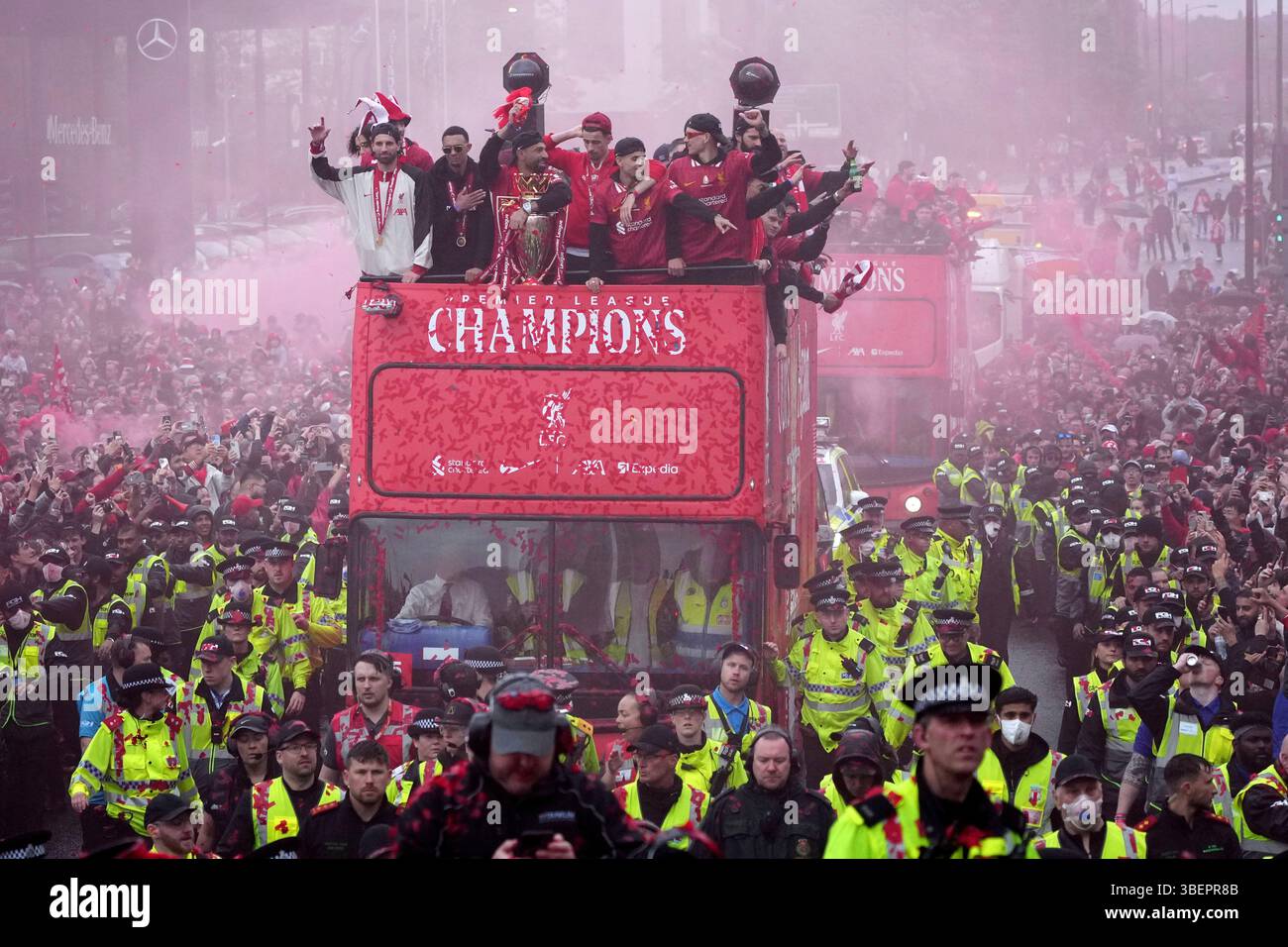 Liverpool players celebrate with the trophy on an open-top bus during ...