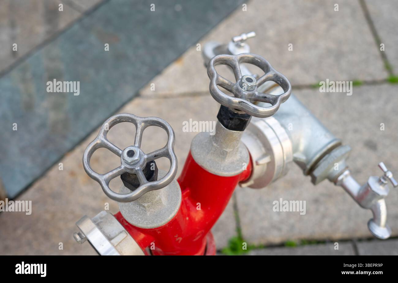 View of two overhead fire hydrant valves in lush red color next to the ...