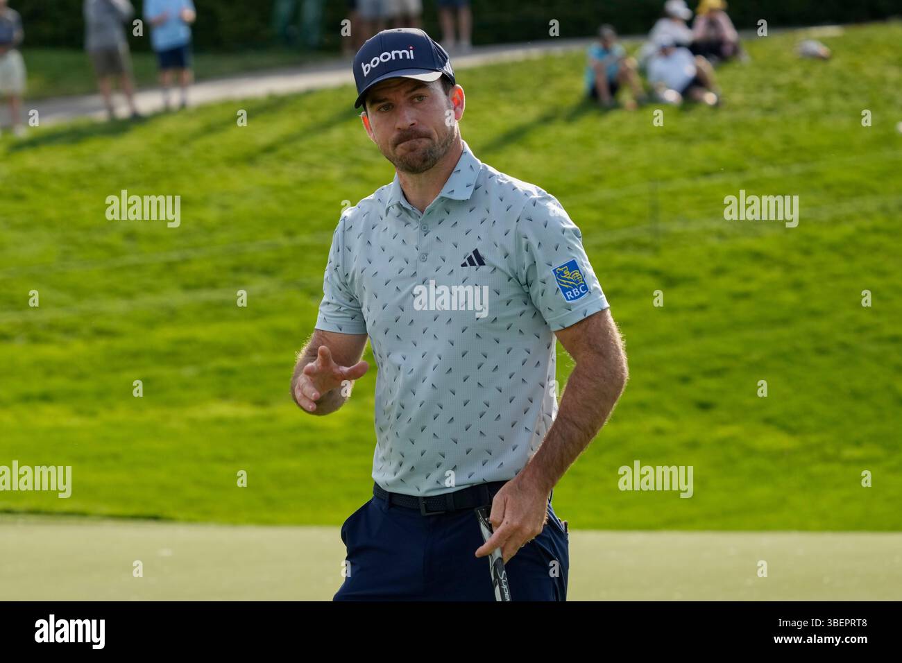Nick Taylor gestures after his putt on the 18th green in the first ...