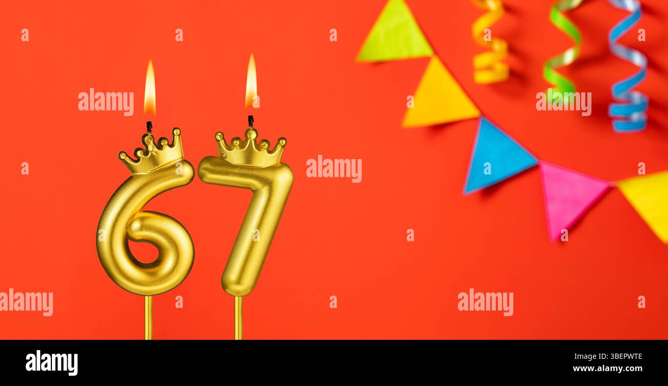 Number 67 birthday candle on an orange background with pennants Stock ...