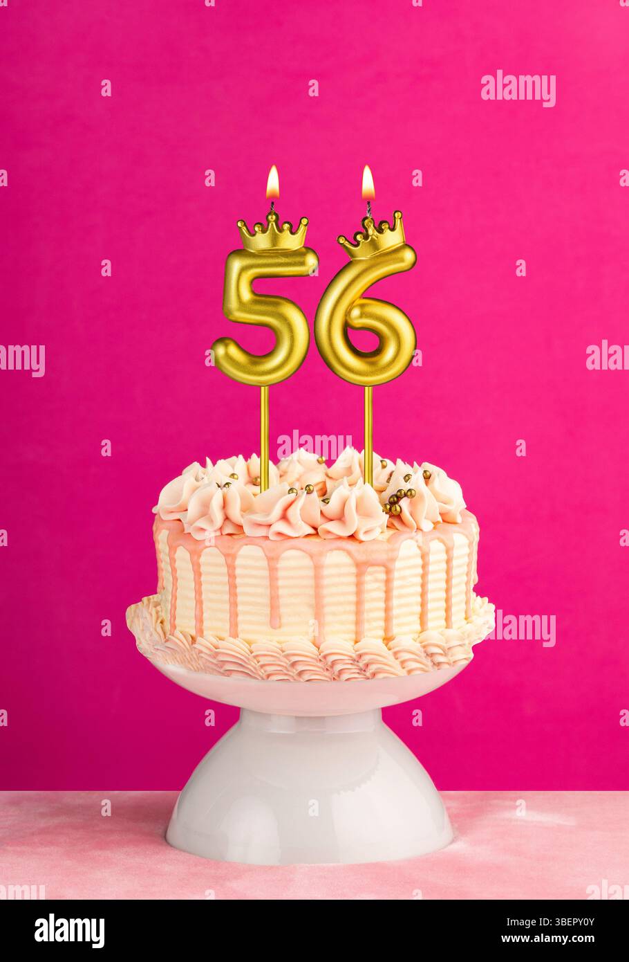 Pink birthday celebration cake with number 56 candle Stock Photo - Alamy