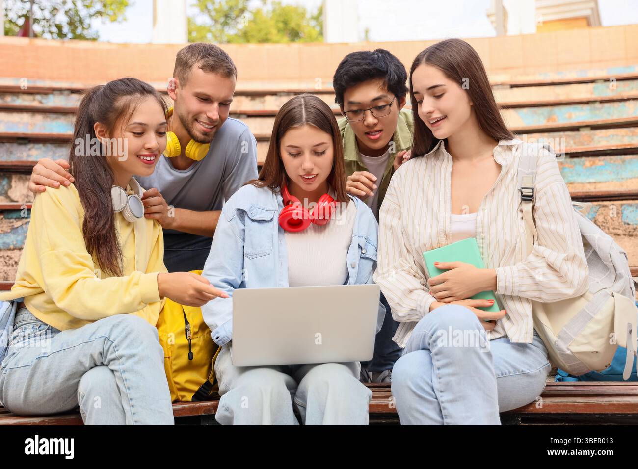 Group of students studying with laptop on benches outdoors Stock Photo ...