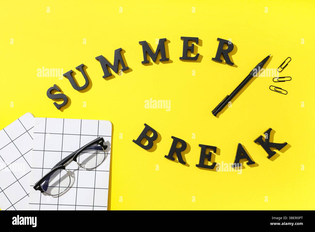Composition with text SUMMER BREAK made of dark letters, stationery and ...