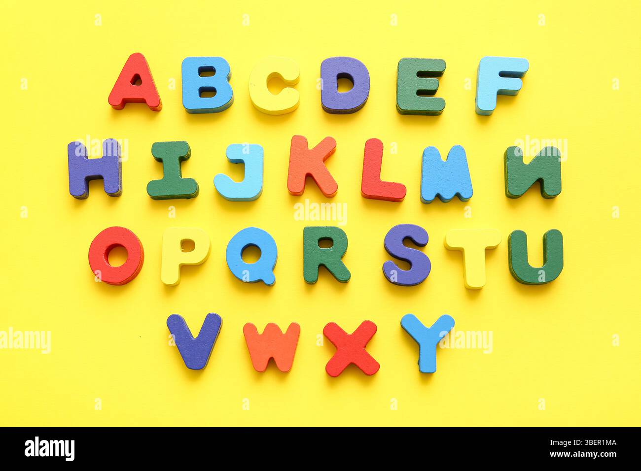Colorful English letters on yellow background Stock Photo - Alamy