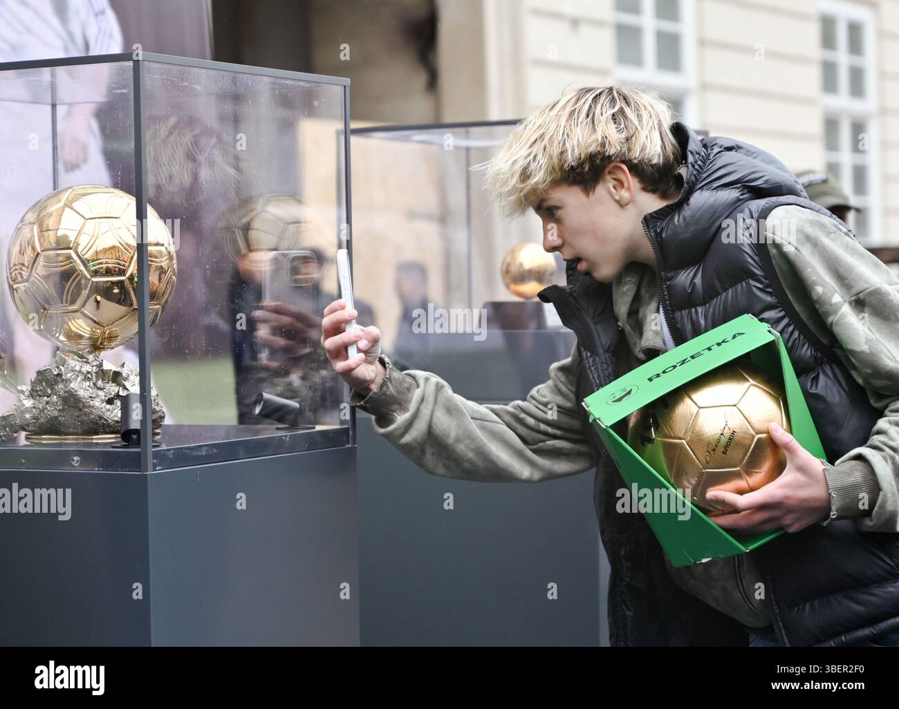A young man takes a photo during the presentation of three Ballon d’Or awards won by Ukrainian ...