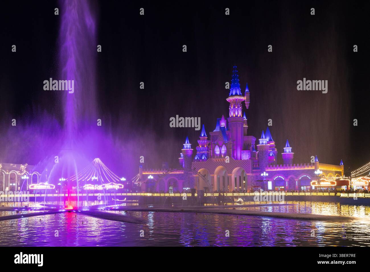 Musical fountains and fairy tale castle at night at the Magic City Park ...