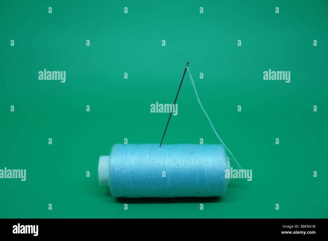 Sewing needle stuck in thread Stock Photo - Alamy
