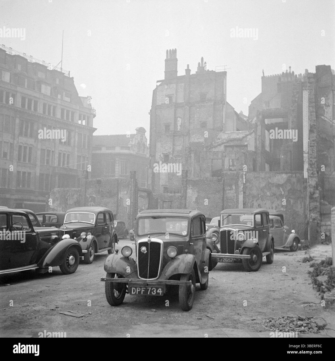 1940s London: Cars in a parking lot between destroyed buildings as ...