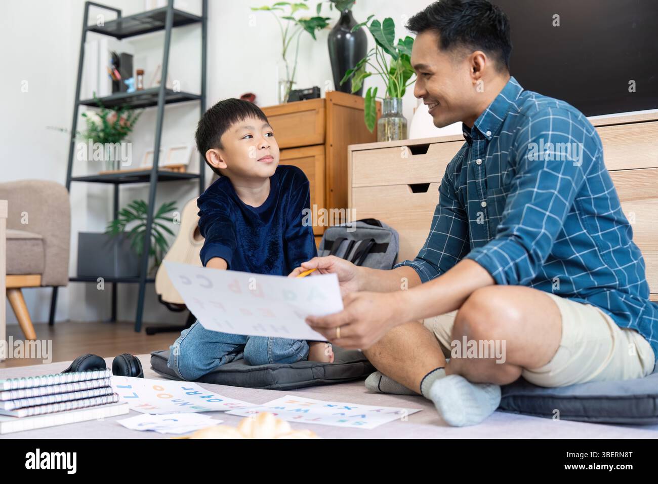 Back to School and Learning Together. A father and son engage in ...