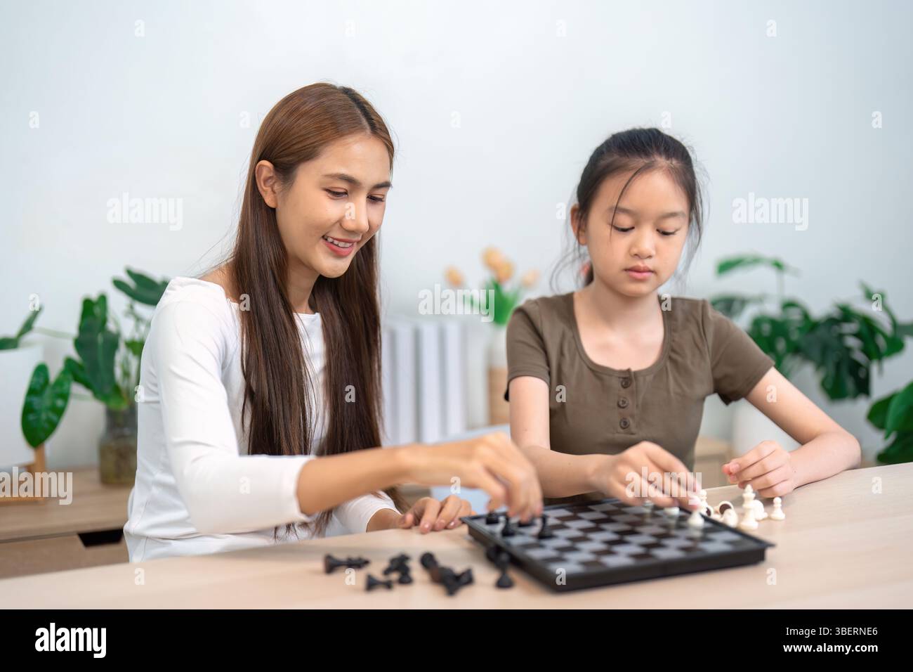 Family Event and Mother. A mother and daughter enjoying a game of chess ...