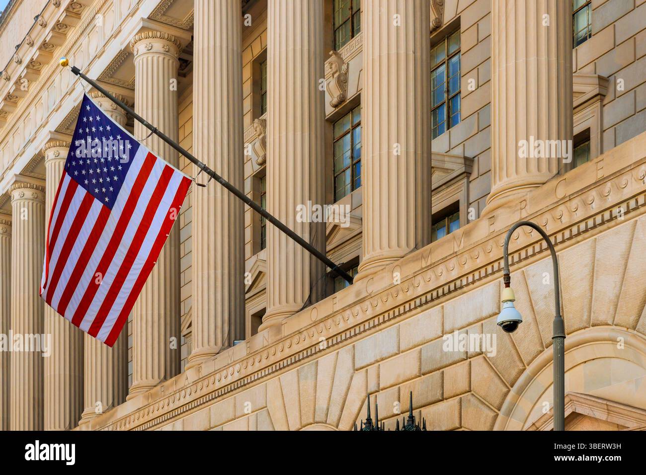 American flag flutters against backdrop of elegant columns ...