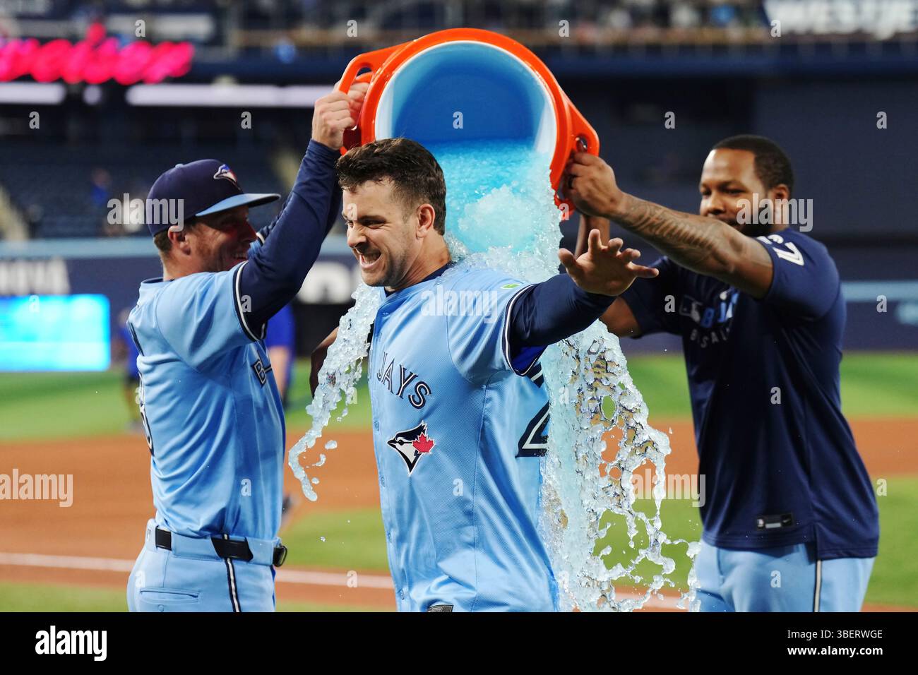 Toronto Blue Jays' Ernie Clement, center, is doused by Myles Straw ...
