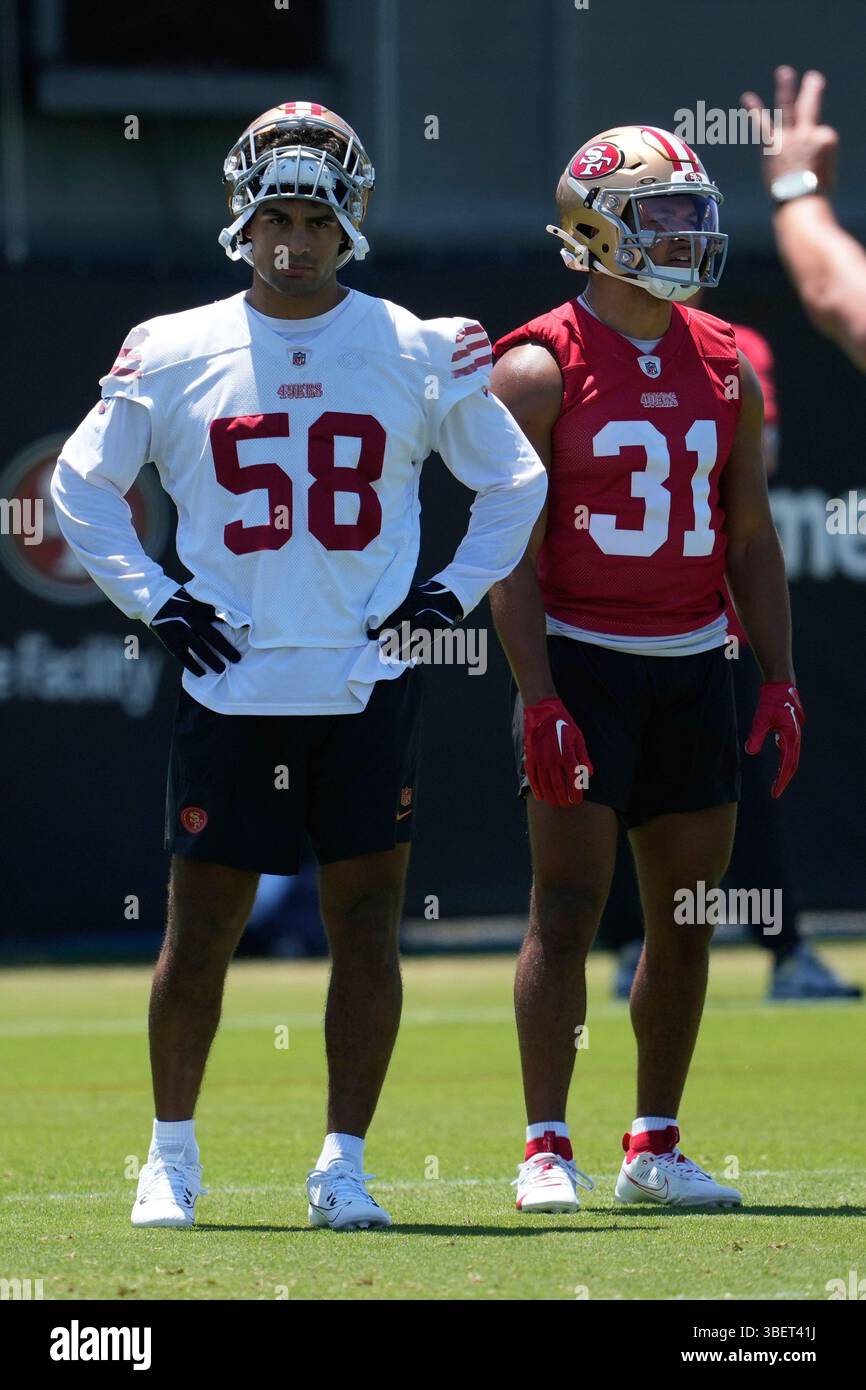 San Francisco 49ers linebacker Chazz Surratt (58) and running back ...