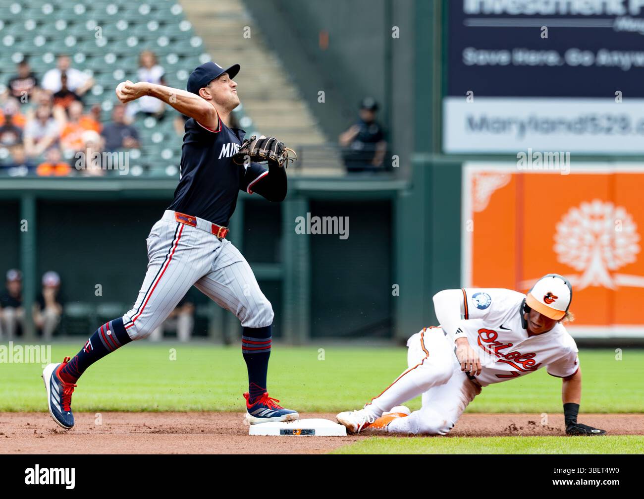 Minnesota Twins second baseman Brooks Lee turns a double play against ...