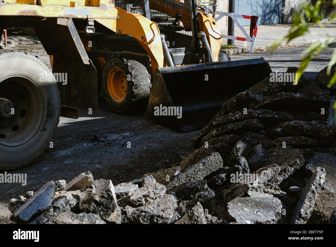 Public Works Scene Showing A Large Yellow Machine Collecting Street ...
