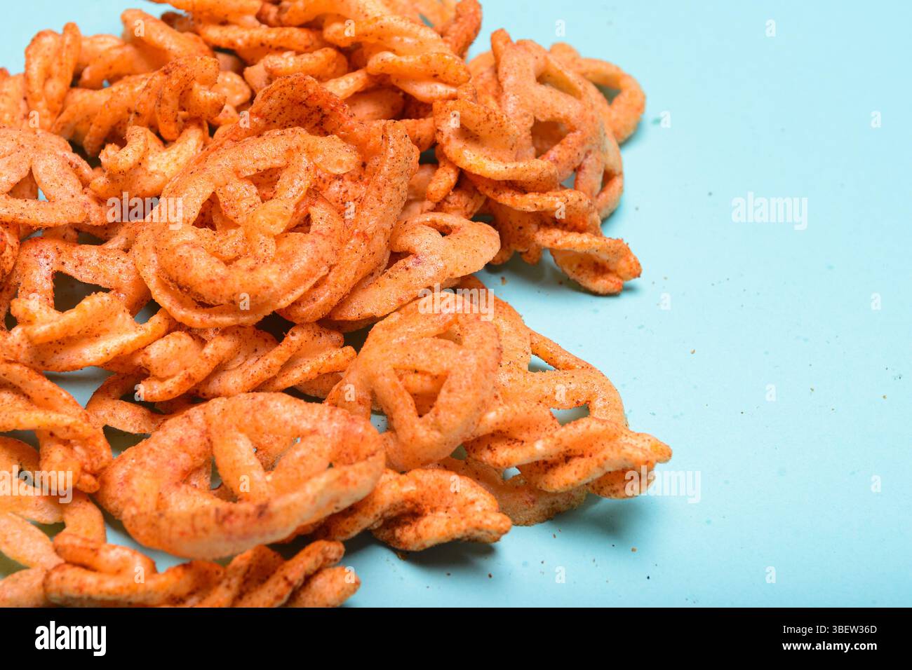 Various shapes of crispy seasoned flour duritos on a pastel blue ...