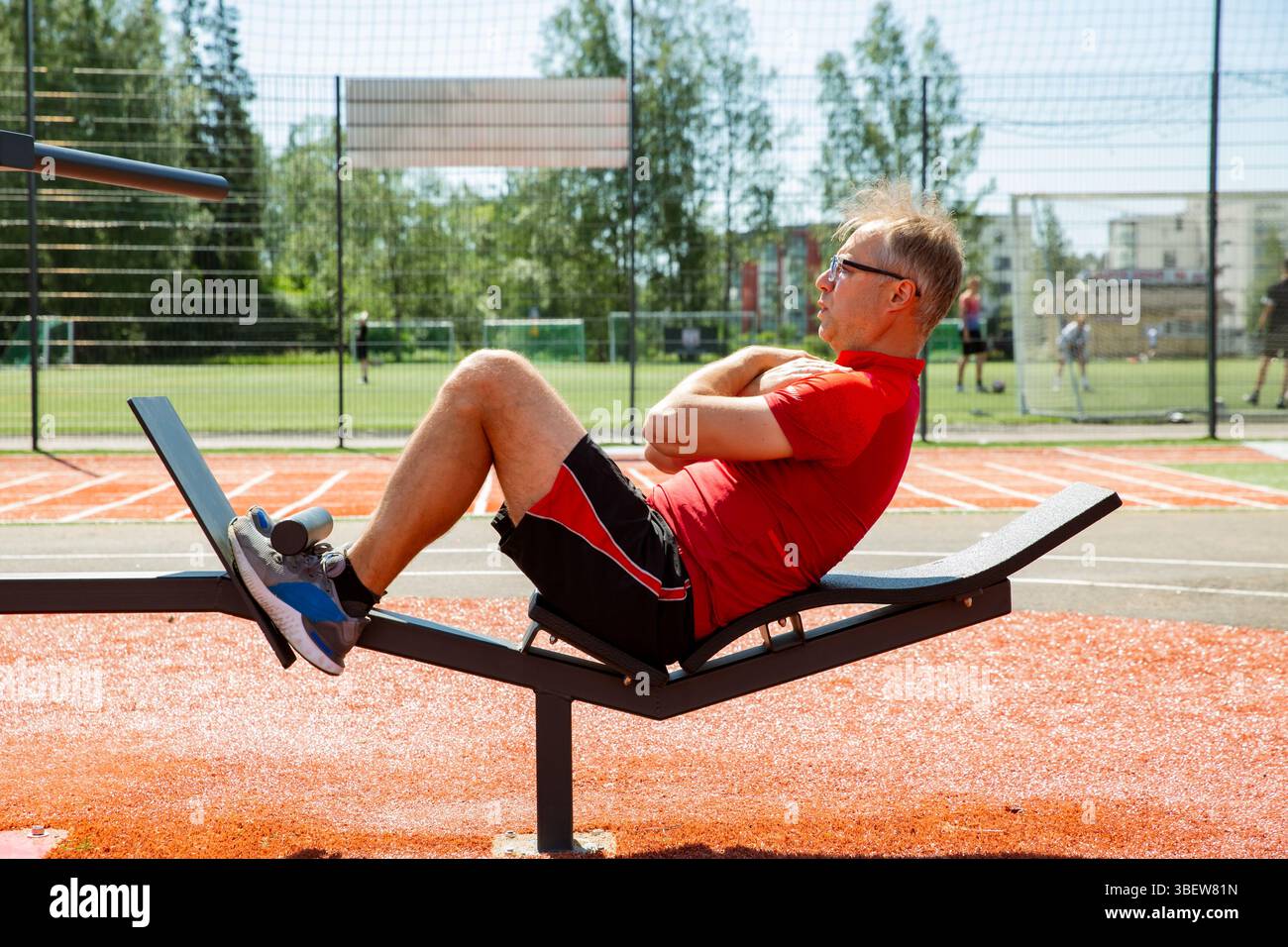Man training on an adjustable abdominal bench. Targets core and abs ...