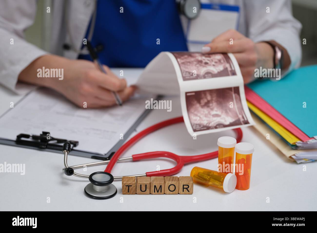 A doctor evaluates tumor images and medication in a clinical setting ...