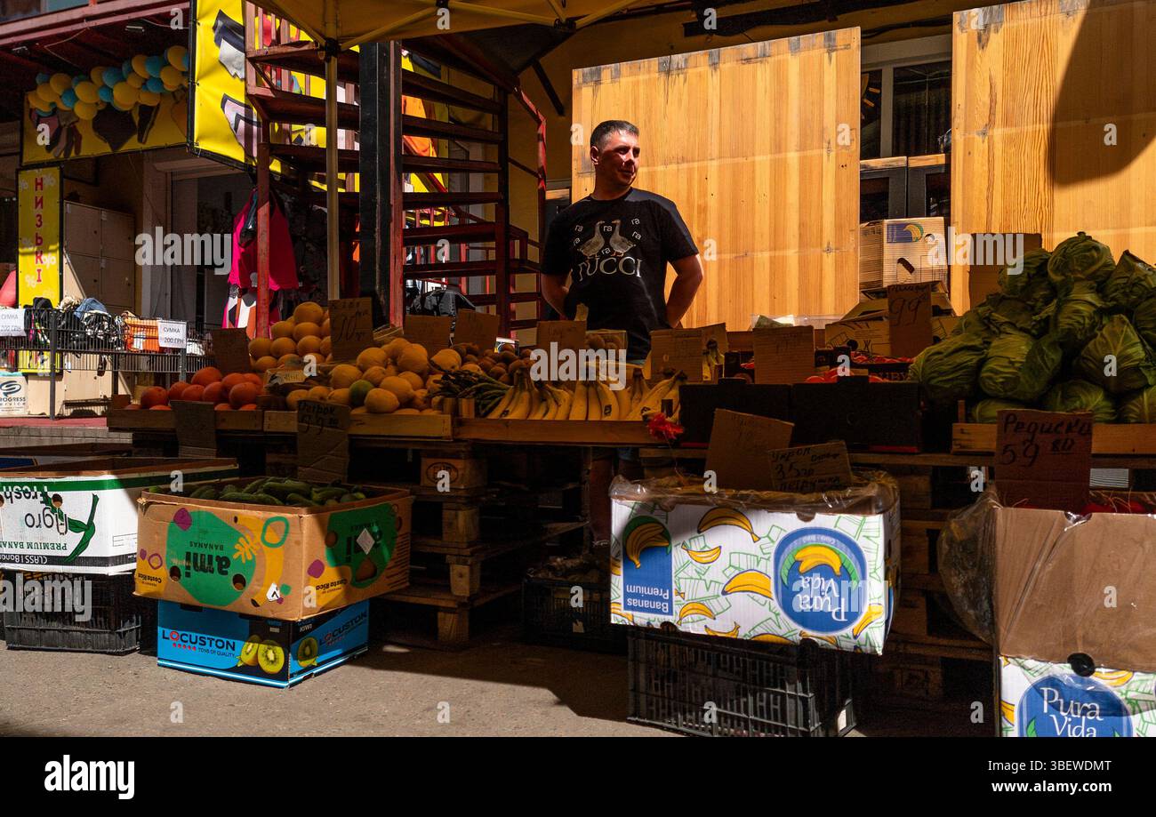 Kyiv, Ukraine - 28th May, 2025: A greengrocer stands proudly at his ...
