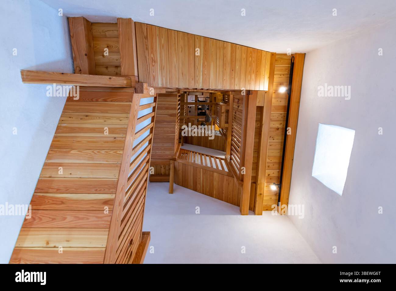 Clock mechanism in the Piran church tower. Wooden stairs in ancient ...
