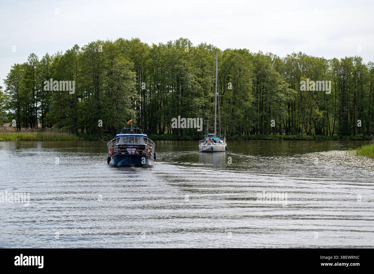 Delta of the Nemuna River, Lithuania - May 24, 2025: Two boats navigate ...
